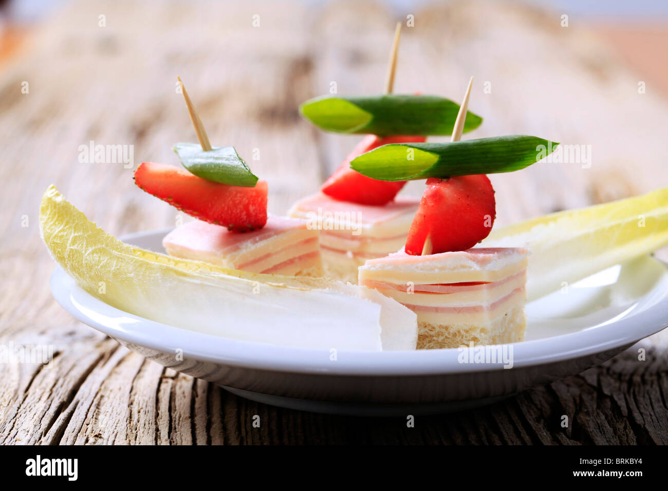 Ham and cheese canapes and endive leaves Stock Photo - Alamy