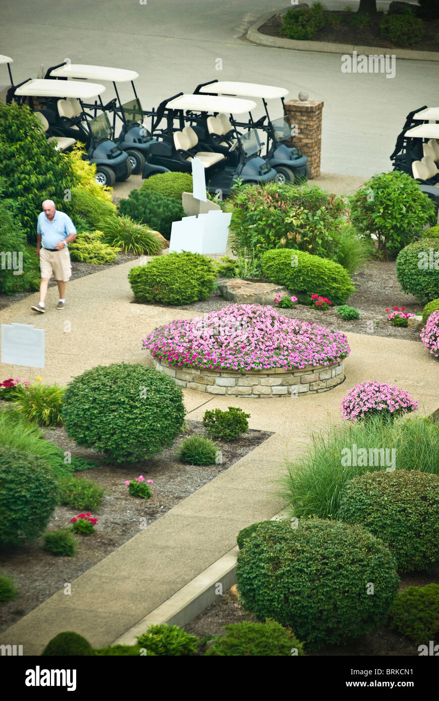Golf carts, player, country club golf course entrance Stock Photo - Alamy