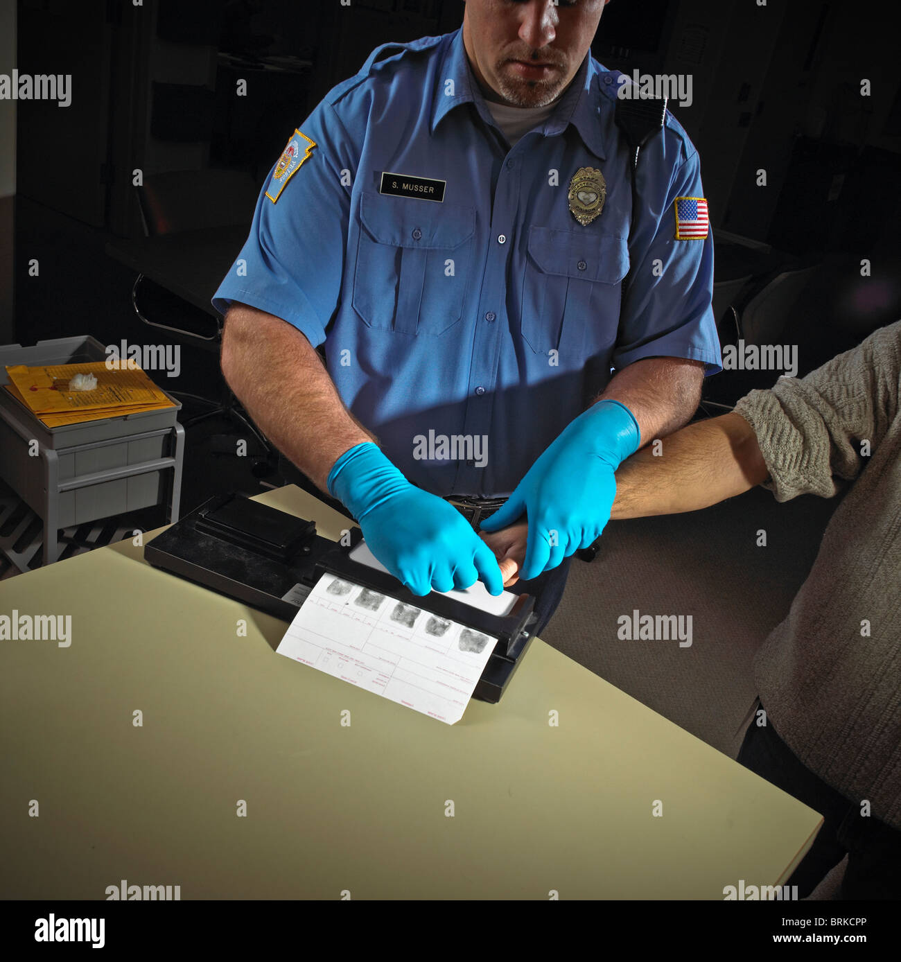 Police officer, security guard, fingerprints criminal suspect prisoner ...