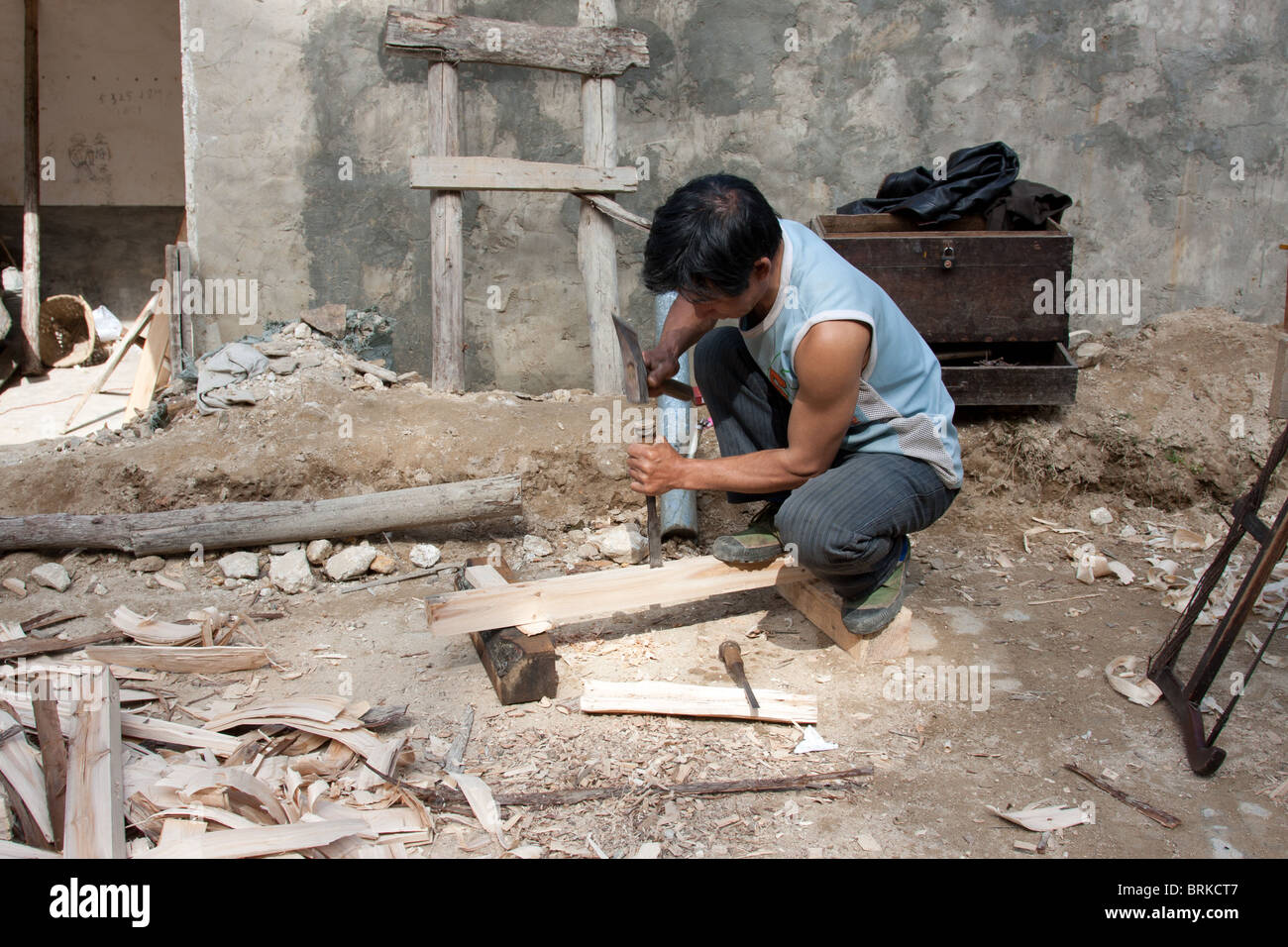 a carpenter chisels a piece of wood Stock Photo - Alamy