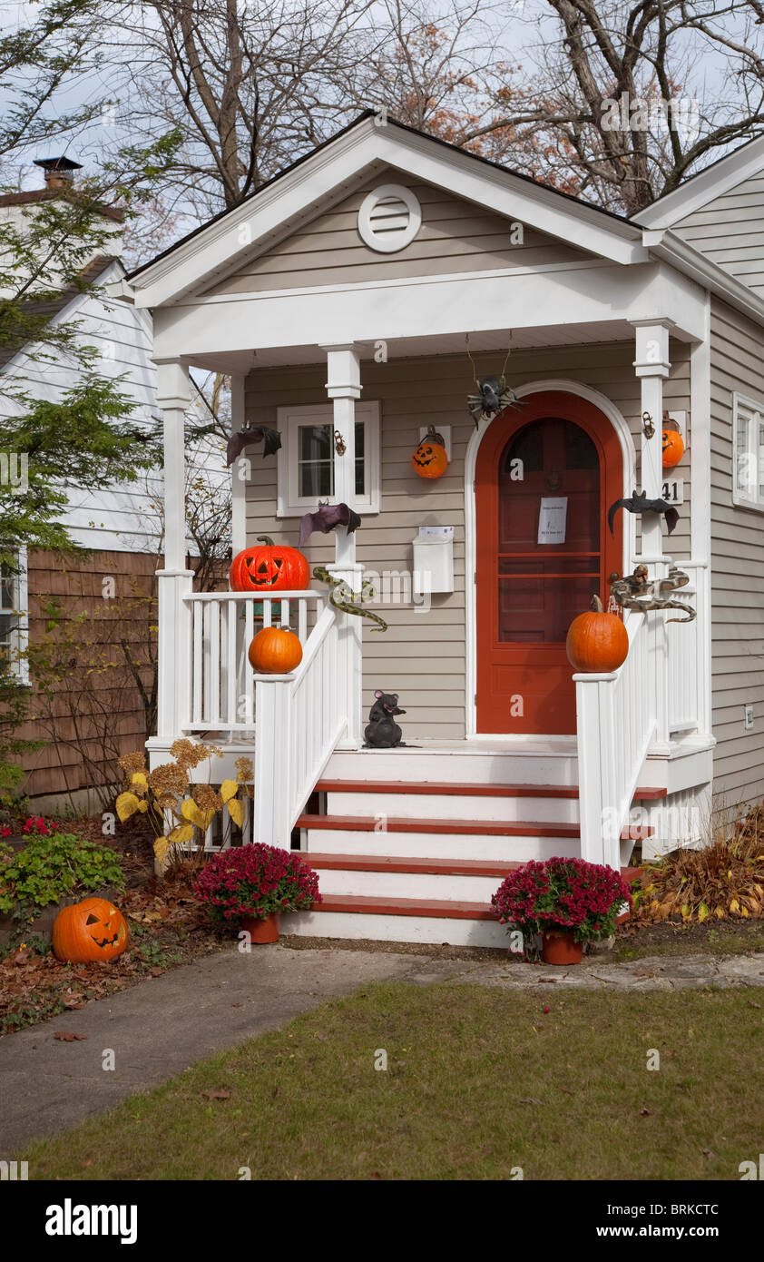 house porch in an american suburb decorated with pumpkins for halloween ...