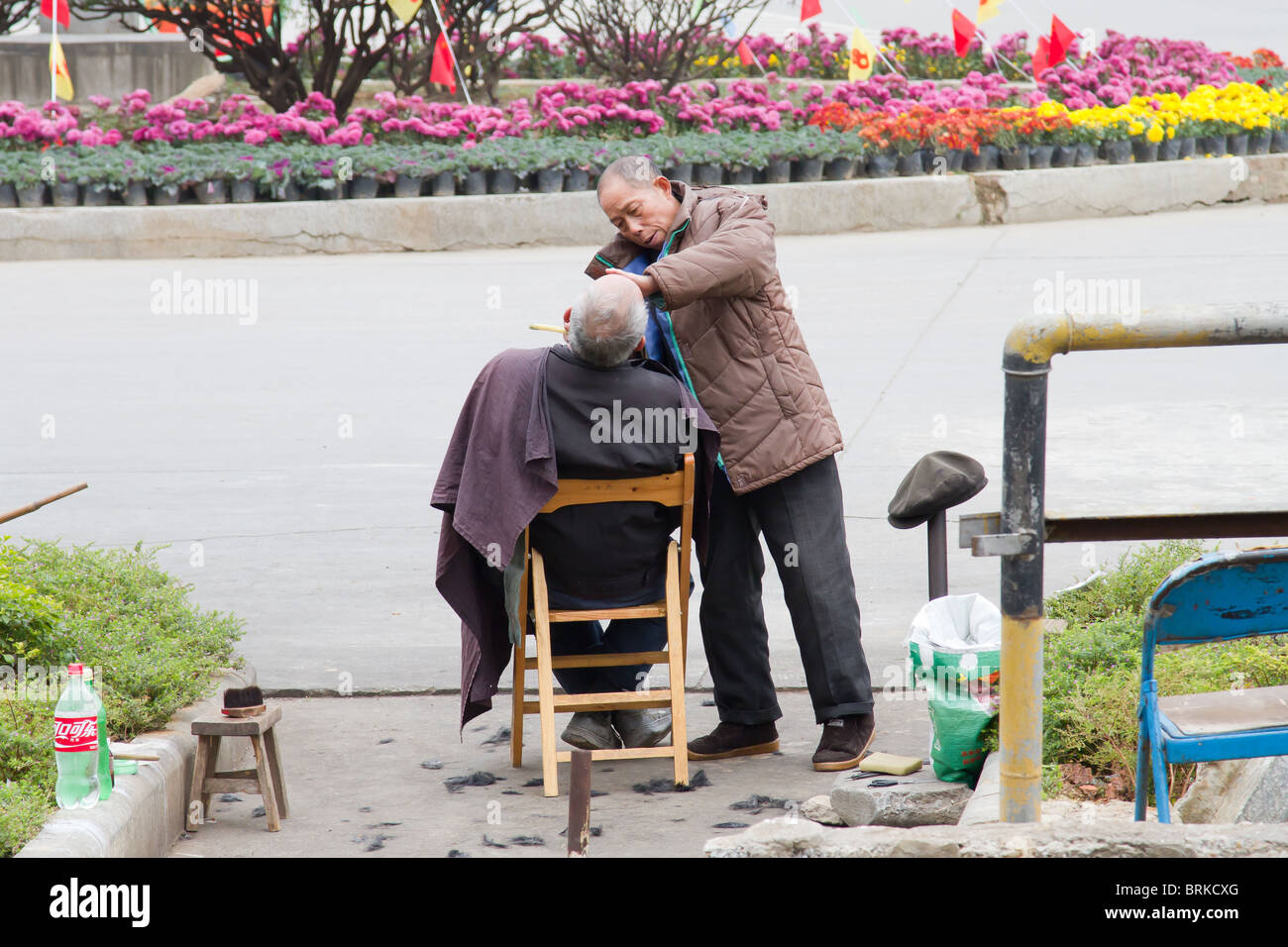 Chinese man shaving a customer in Yangshou, china Stock Photo - Alamy