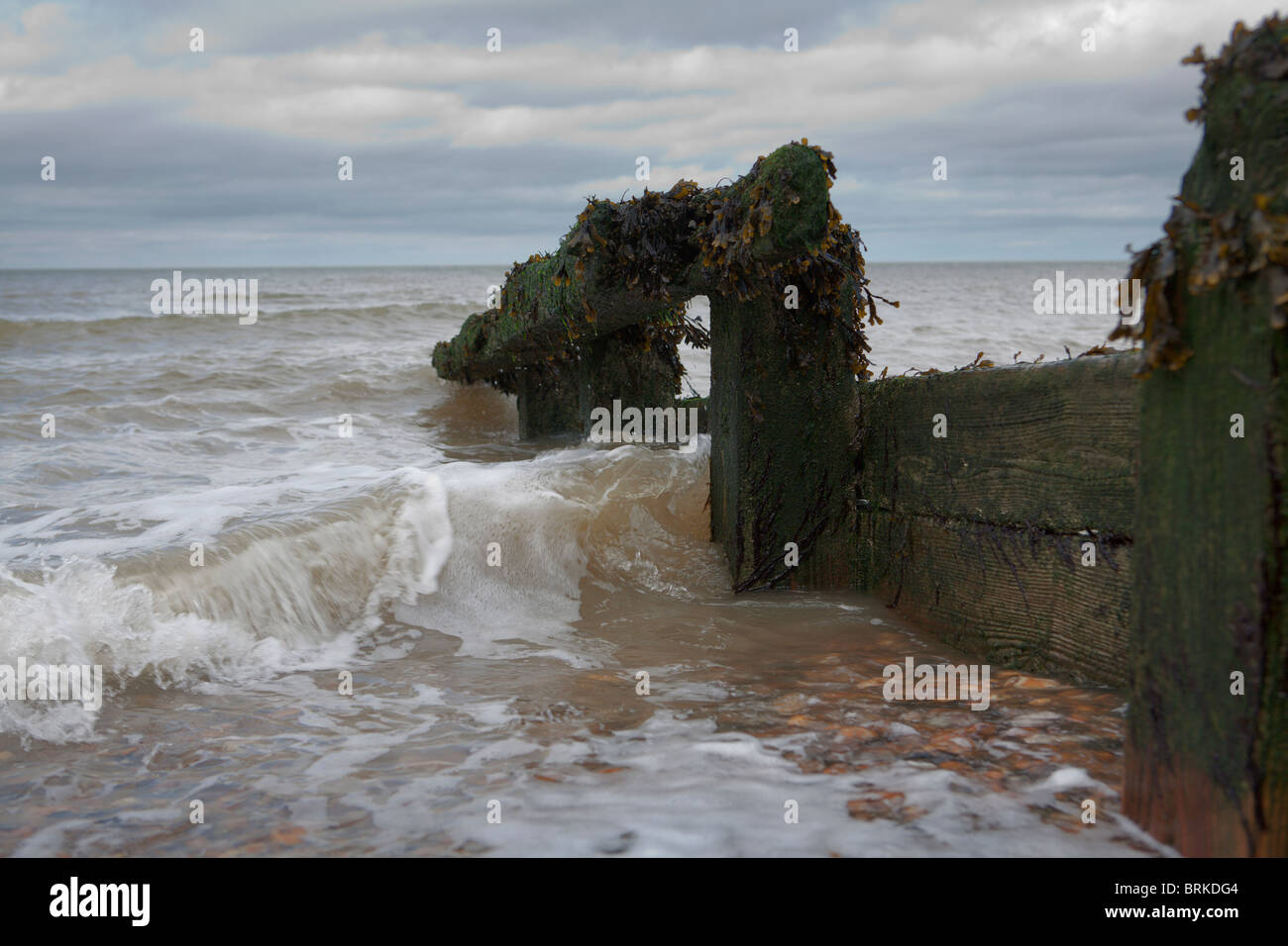 waves breaking againts a barrier Stock Photo - Alamy
