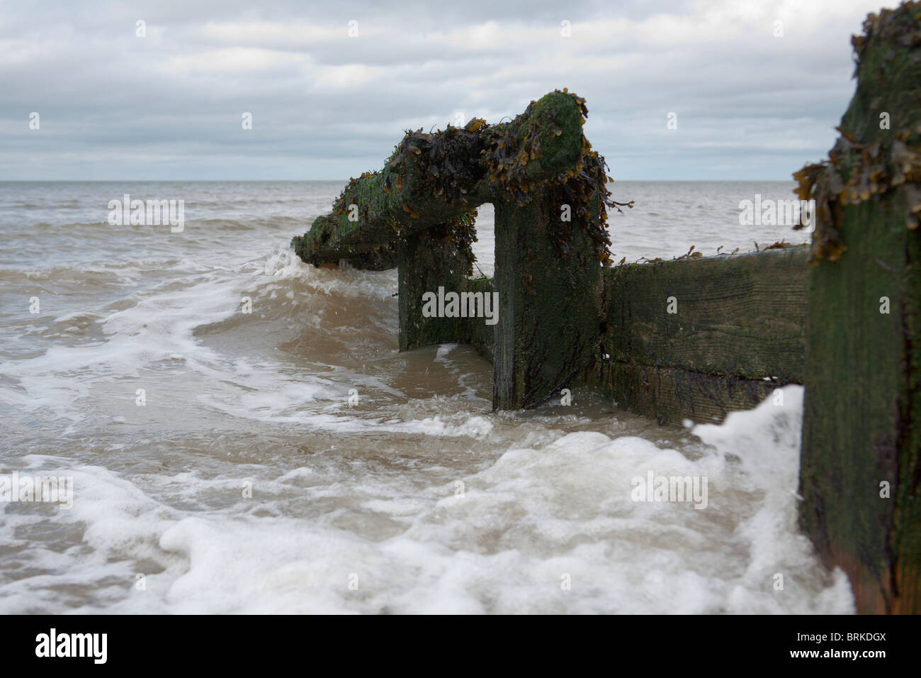 waves breaking againts a barrier Stock Photo - Alamy