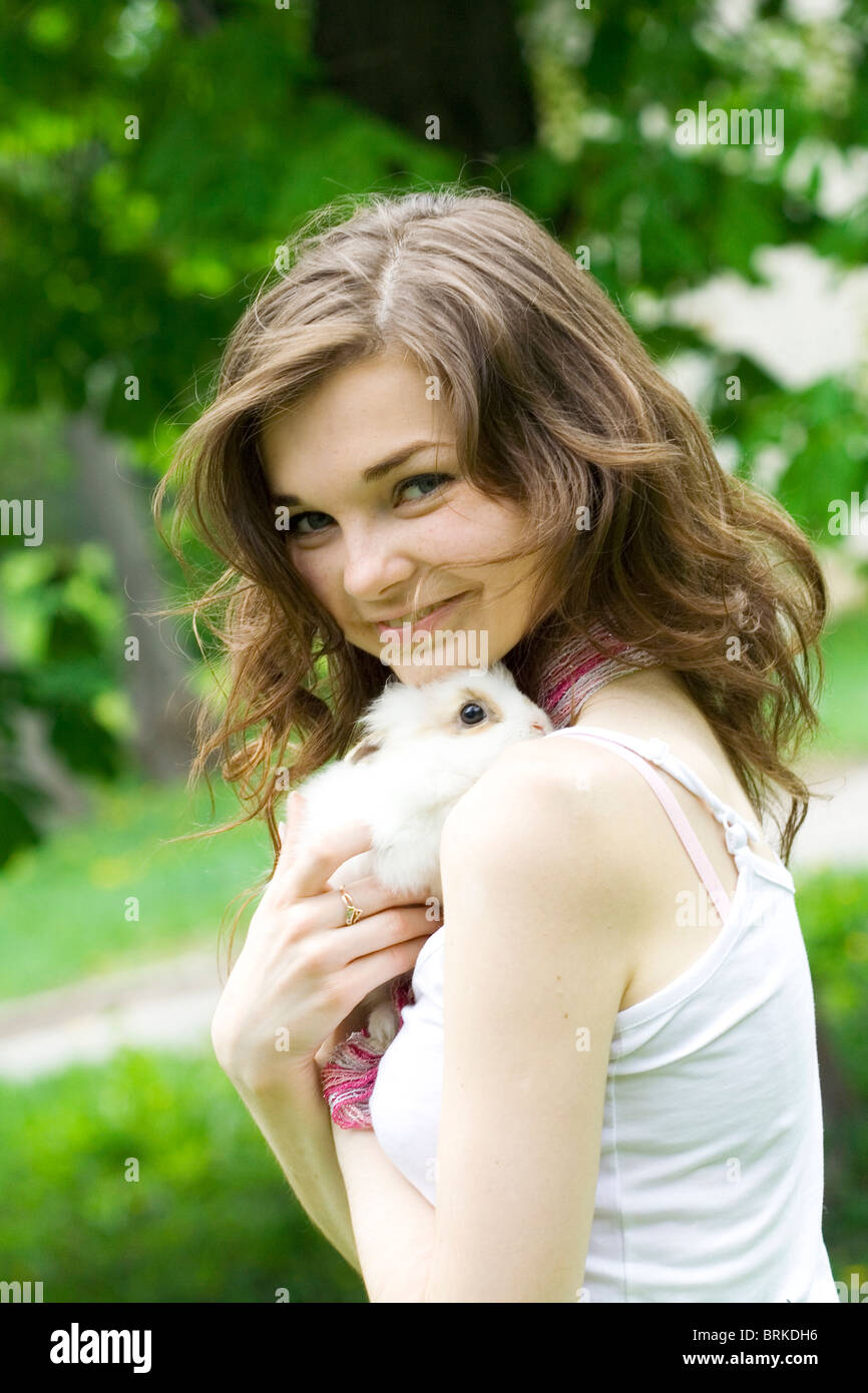 Young girl with white rabbit Stock Photo - Alamy