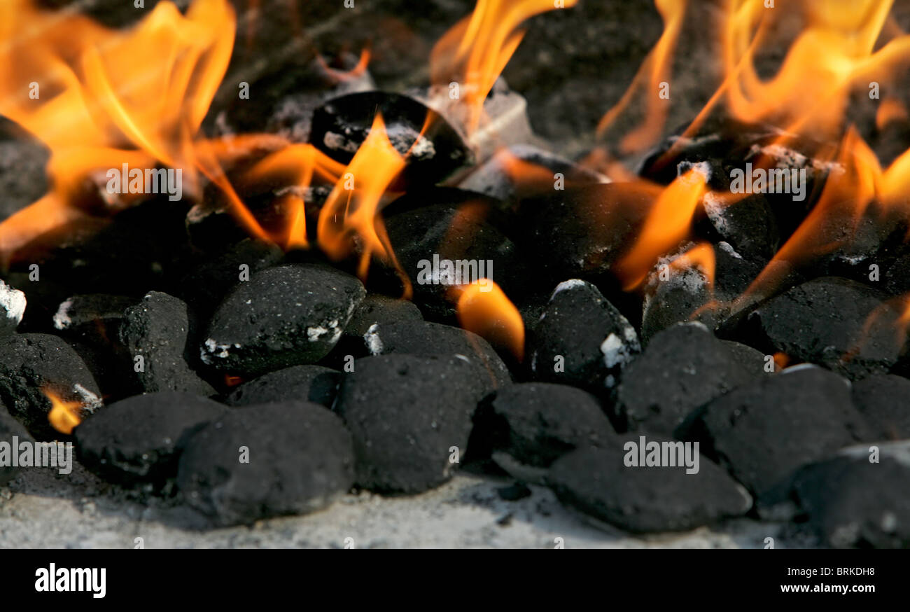 burning charcoal biscuits set on fire in a barbecue grill Stock Photo ...