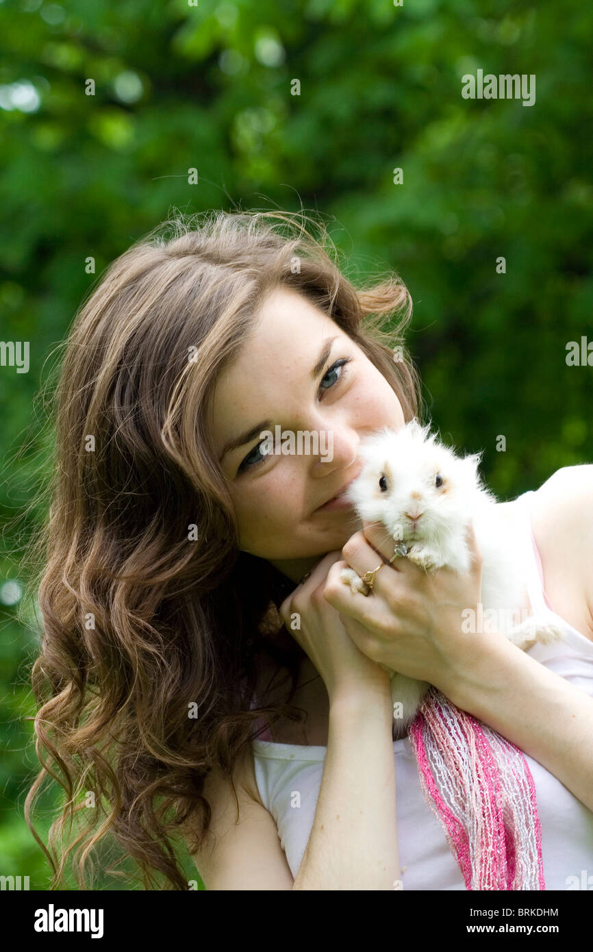 Young girl with white rabbit Stock Photo - Alamy