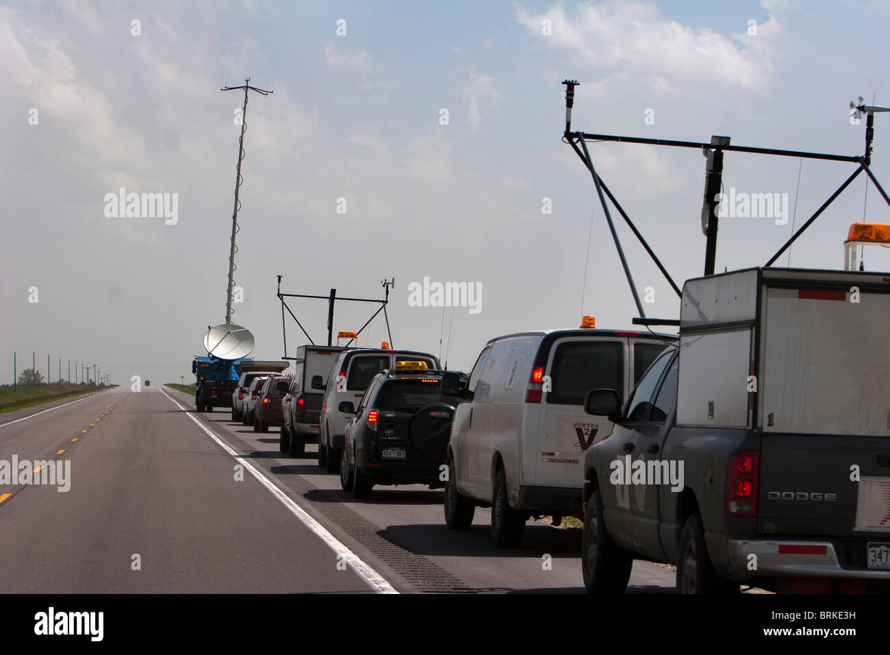 Storm chasers with Project Vortex 2 line up along a highway in rural ...