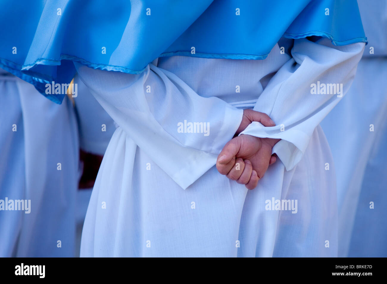 Clasped hands of a man leading a Catholic religious procession at ...