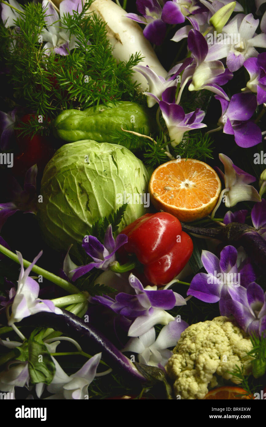 A float with offerings of fruit, vegetables, and flowers is on display ...