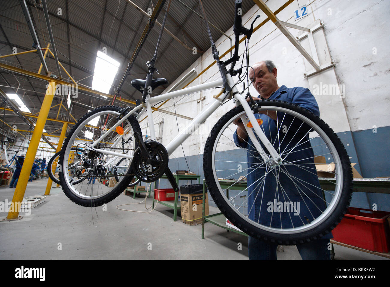 Worker at the assembly line of a bicycle factory Stock Photo - Alamy