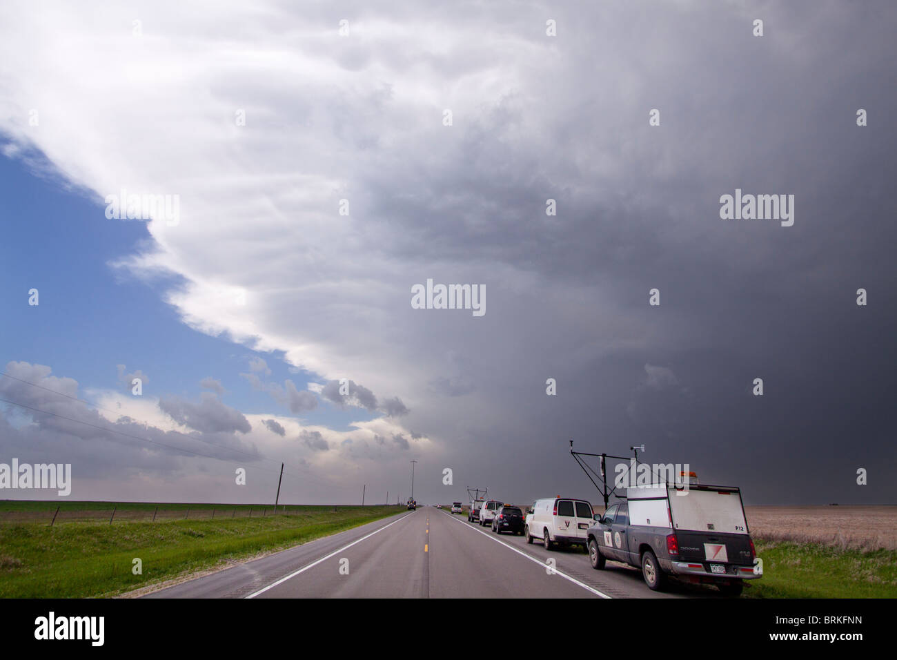 Storm chasers with Project Vortex 2 line up along a highway in rural ...