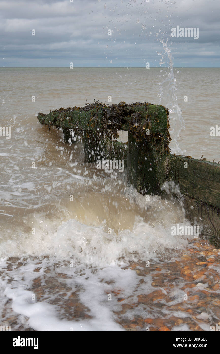 waves breaking againts a barrier Stock Photo - Alamy