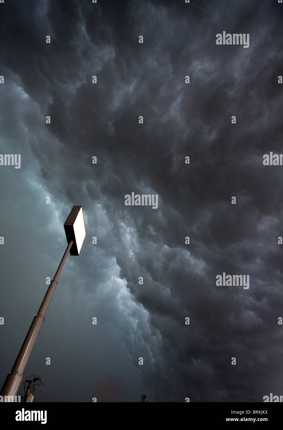 A large sign stands against the roiling clouds of a severe squall line ...