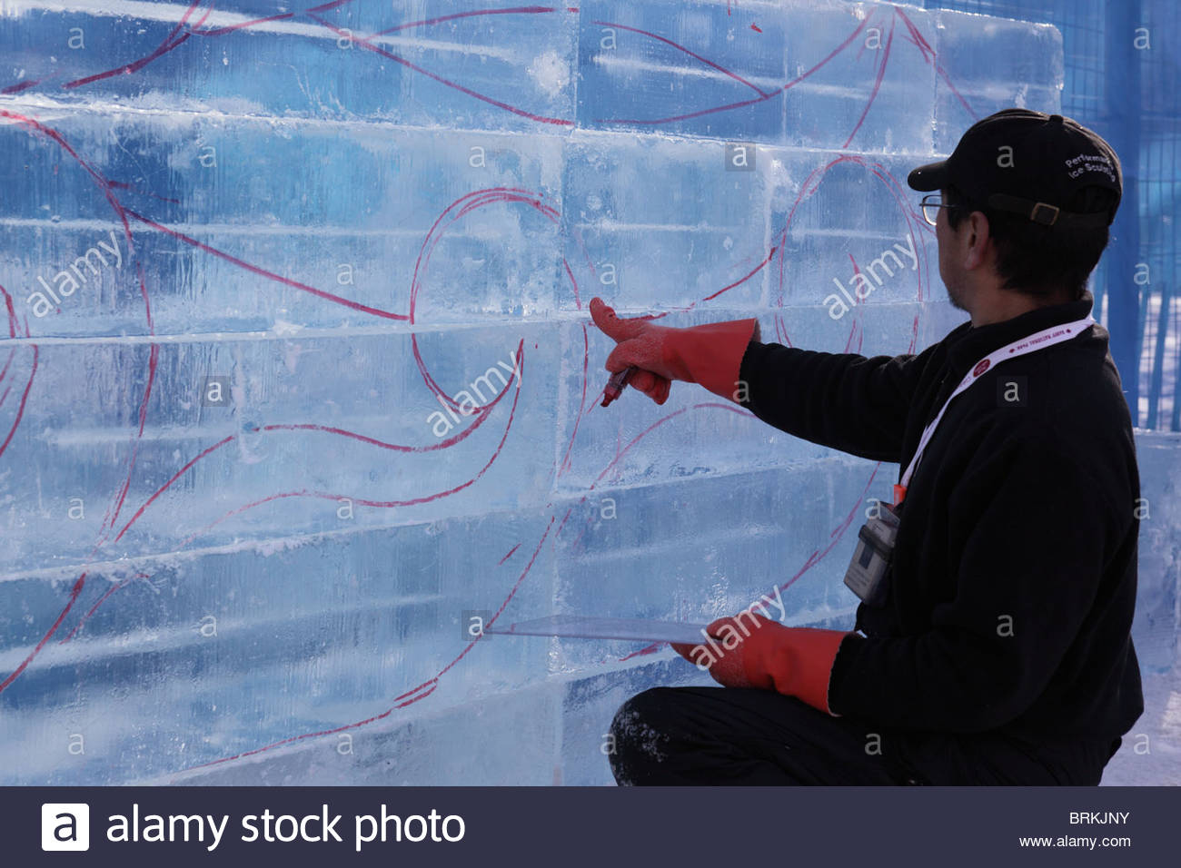 An Ice sculptor marks his design in preparation for carving Stock Photo ...