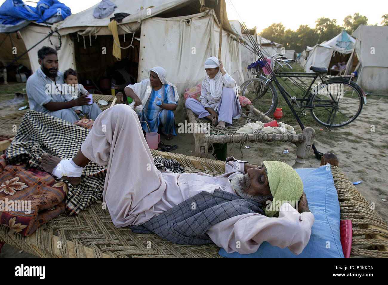 Flood affectees take rest outside their make shift tent houses at ...