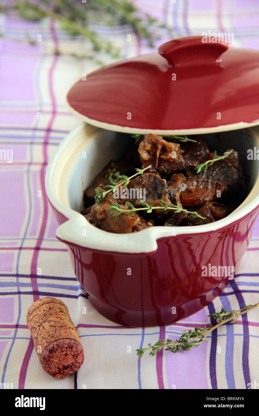 Meat meal in burgundy pot on the table Stock Photo - Alamy