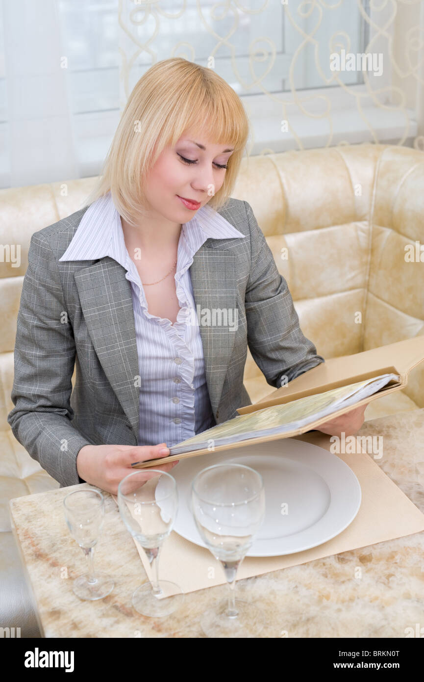 young blonde woman reading menu at first class restaurant Stock Photo ...