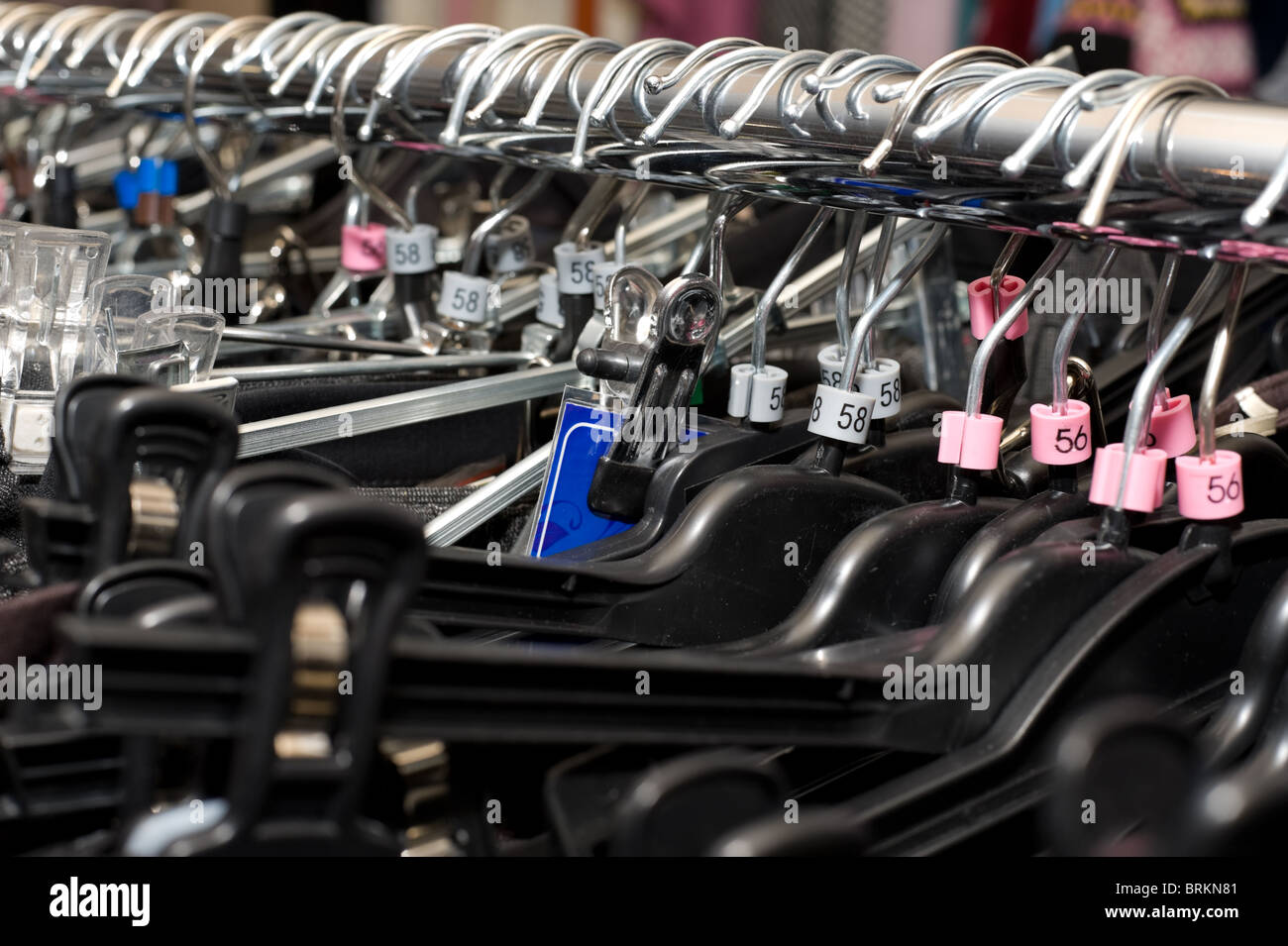 a line of hangers of different sizes at a clothing store Stock Photo ...