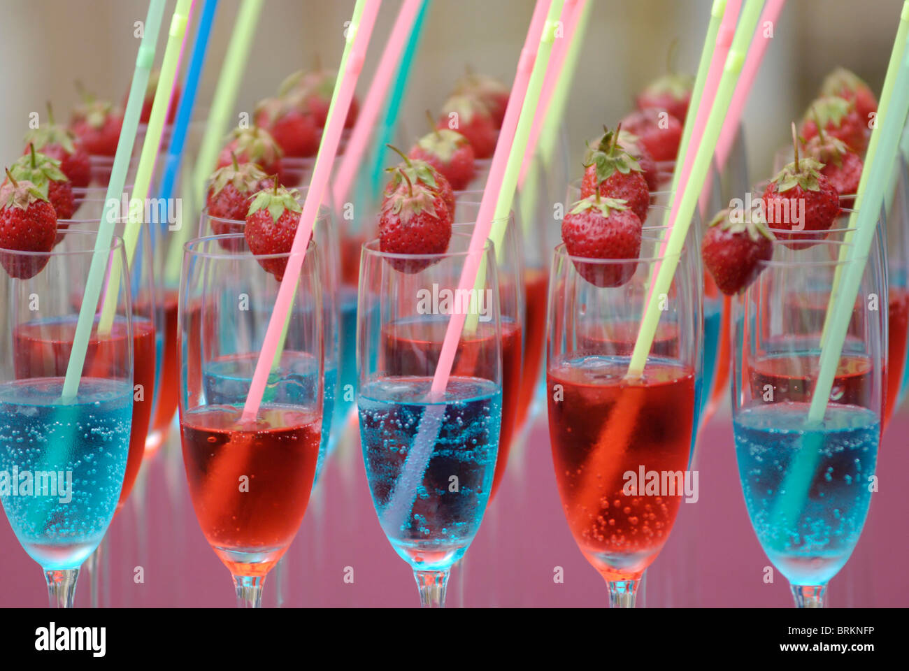 close-up of misted up wine glasses with blue and red drinks, coloured ...