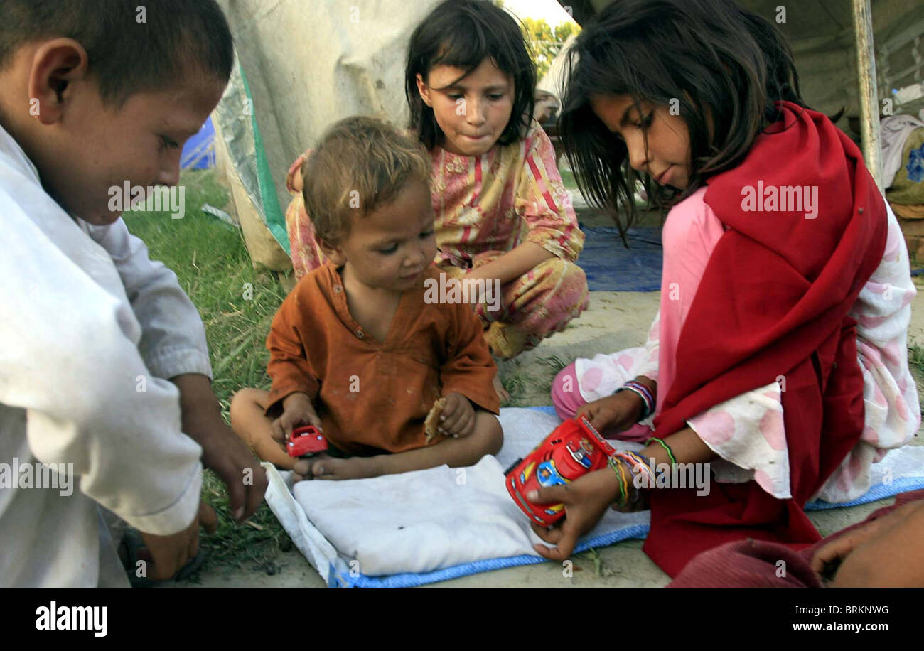 Flood affectees children play with toys at their make shift tent house ...