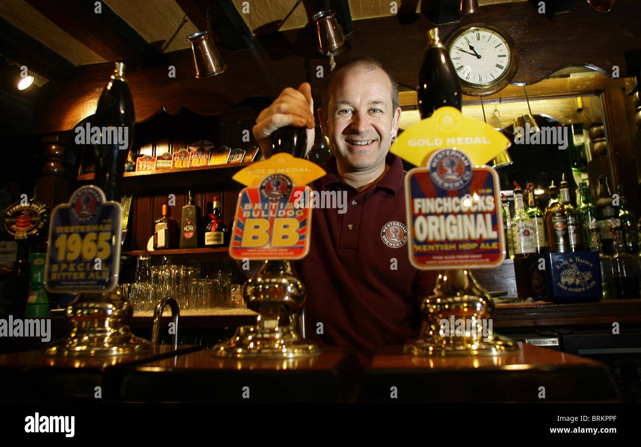 The landlord pours a pint at the Old Eden Pub in Edenbridge Kent ...