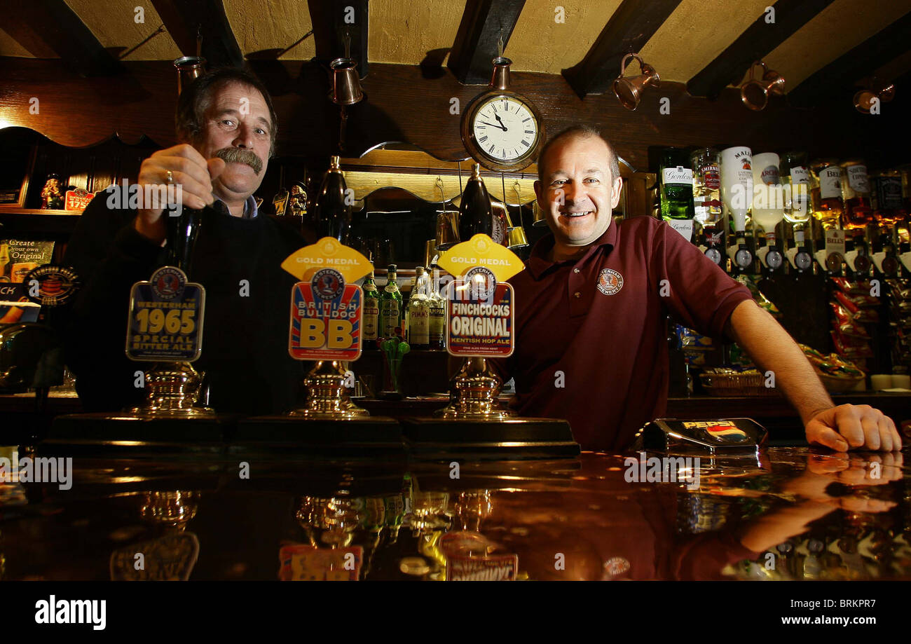 The landlord pours a pint at the Old Eden Pub in Edenbridge Kent ...