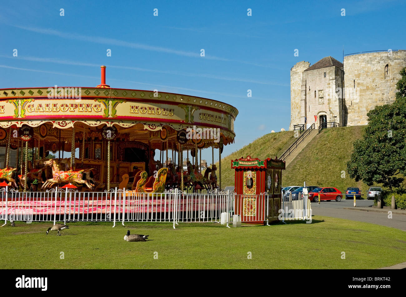 Fairground Ride carousel roundabout with Clifford’s Tower in the ...