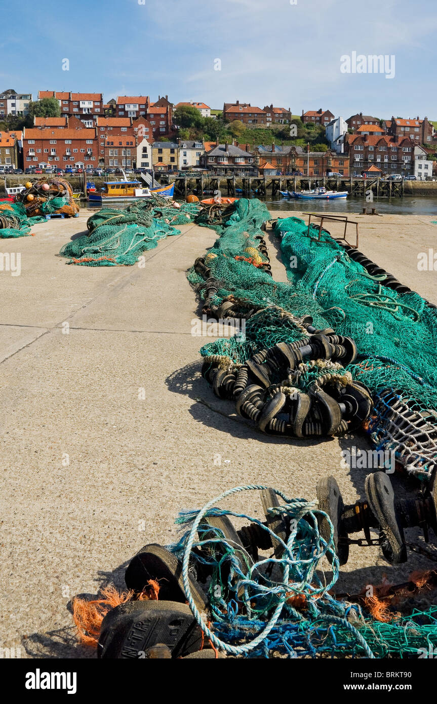 Fishing nets laid out drying on the quayside in summer Whitby Harbour ...