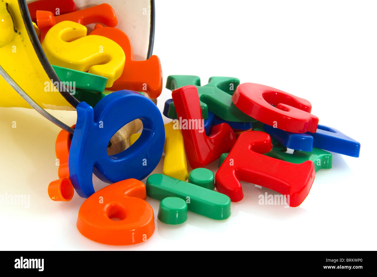 fallen bucket with plastic ciphers and letters isolated over white ...