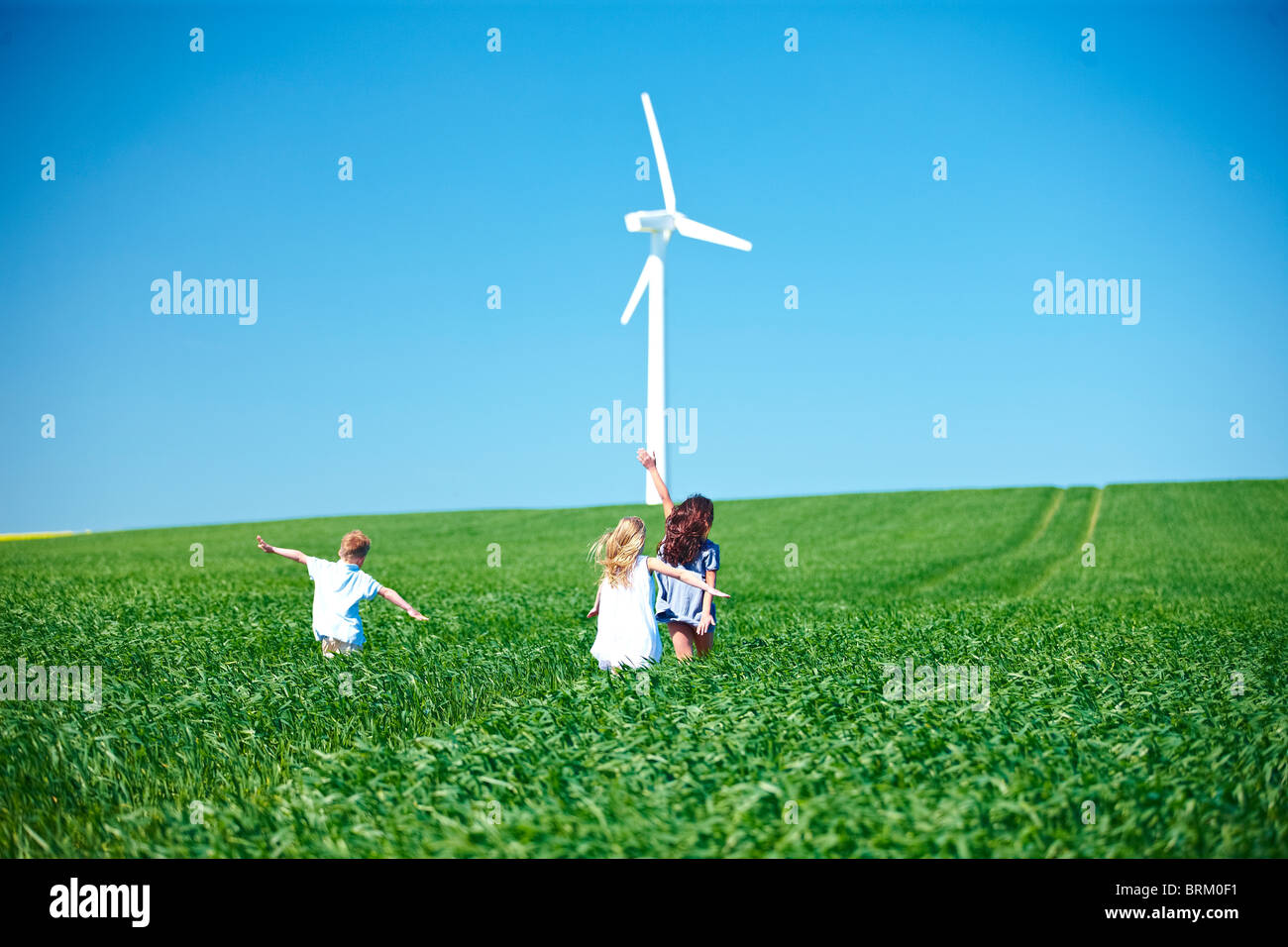 Wind turbine and childrens play in field Stock Photo - Alamy
