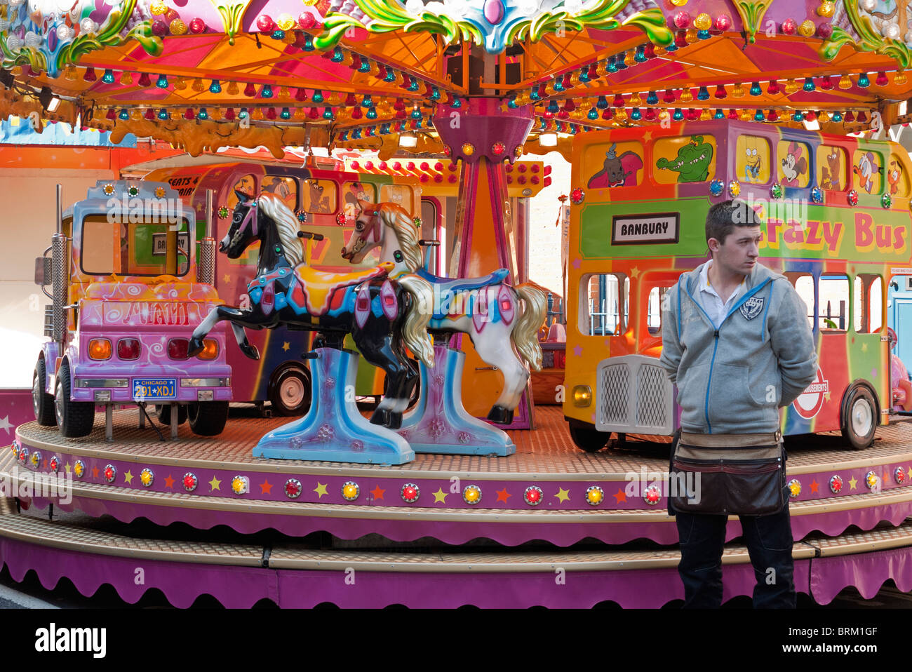 Carnie at merry-go-round - Abingdon Fair in Oxfordshire Stock Photo - Alamy