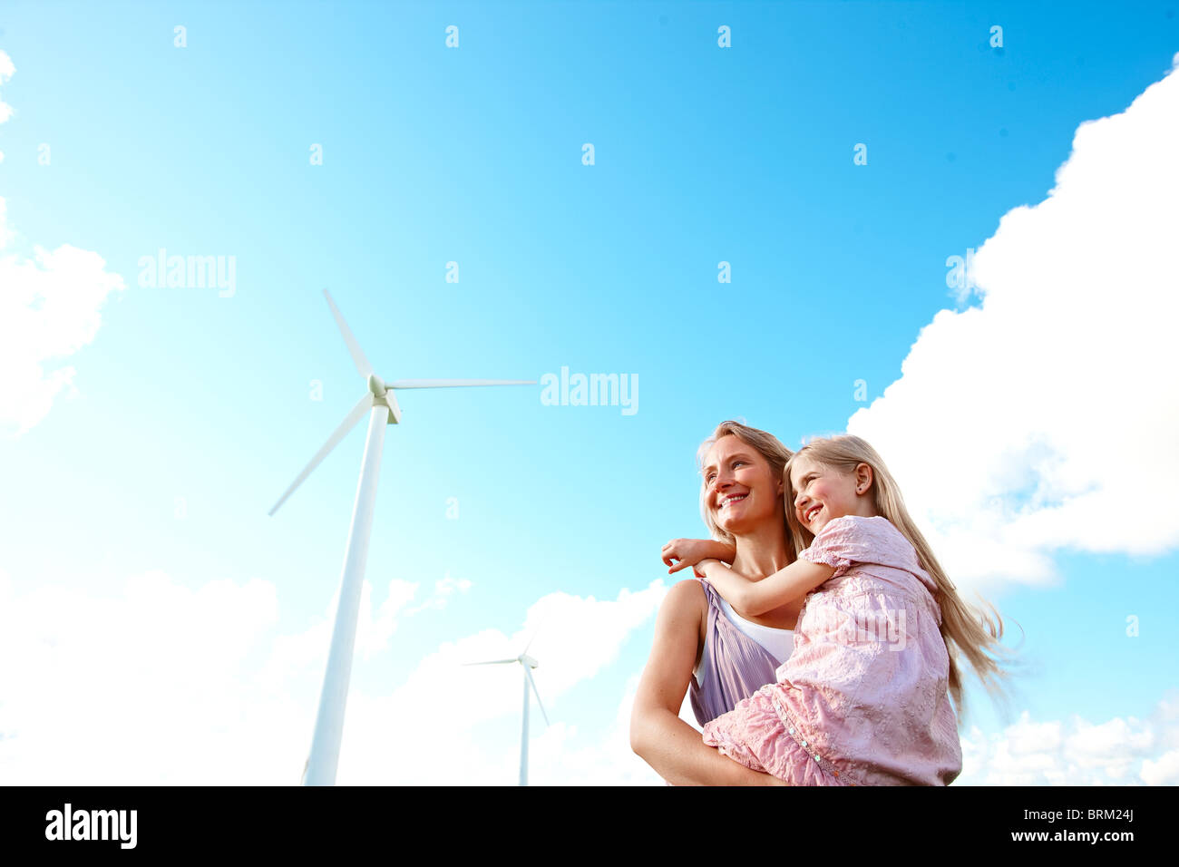 Mother and daughter at wind turbine Stock Photo - Alamy