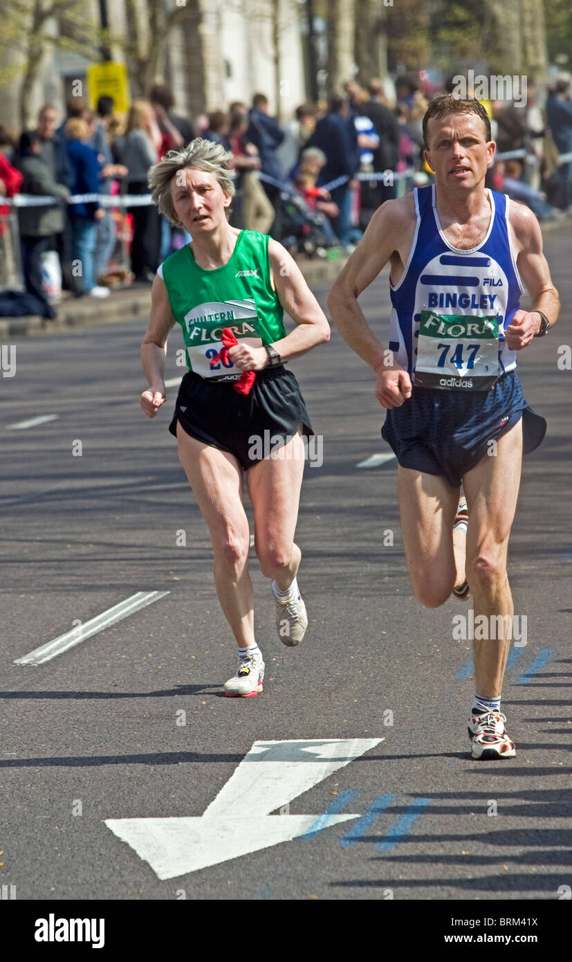 male and female competitive runners taking part in the London Marathon ...