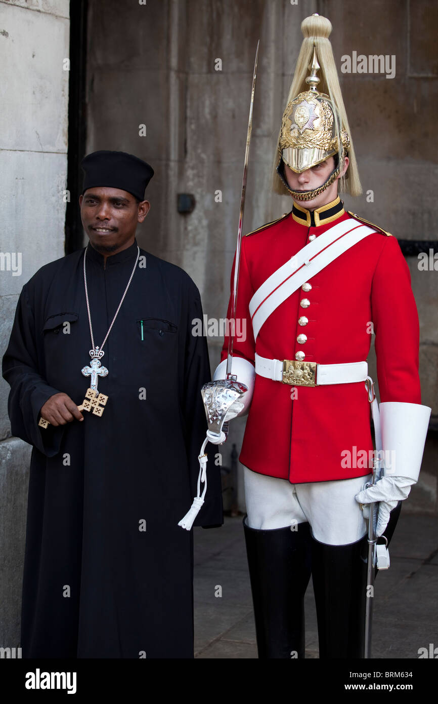 Ethiopian Christian tourist poses for a photograph next to a Household ...