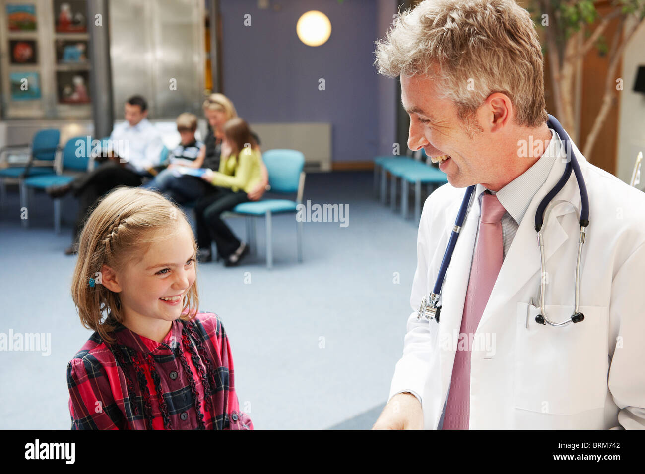 Doctor and patients in waiting area Stock Photo - Alamy
