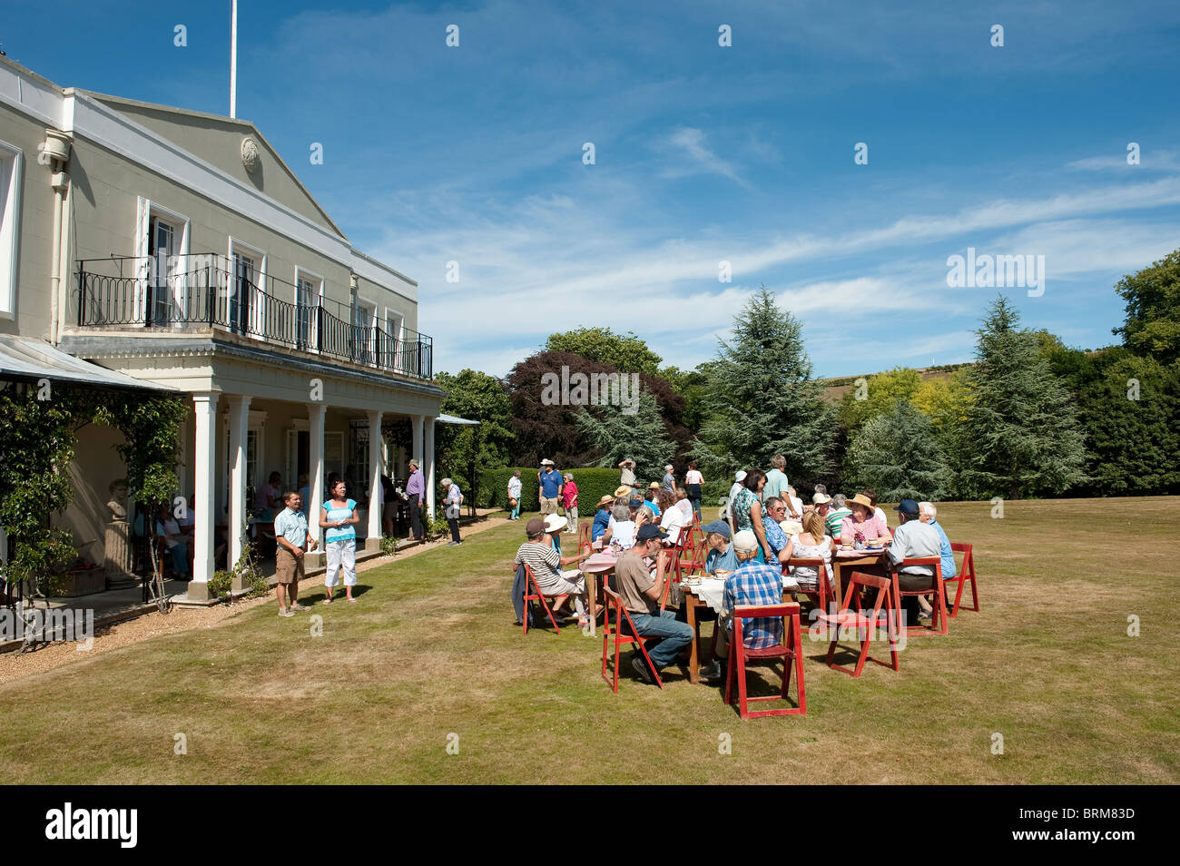 Group of people enjoying refreshments at a garden party in the grounds ...