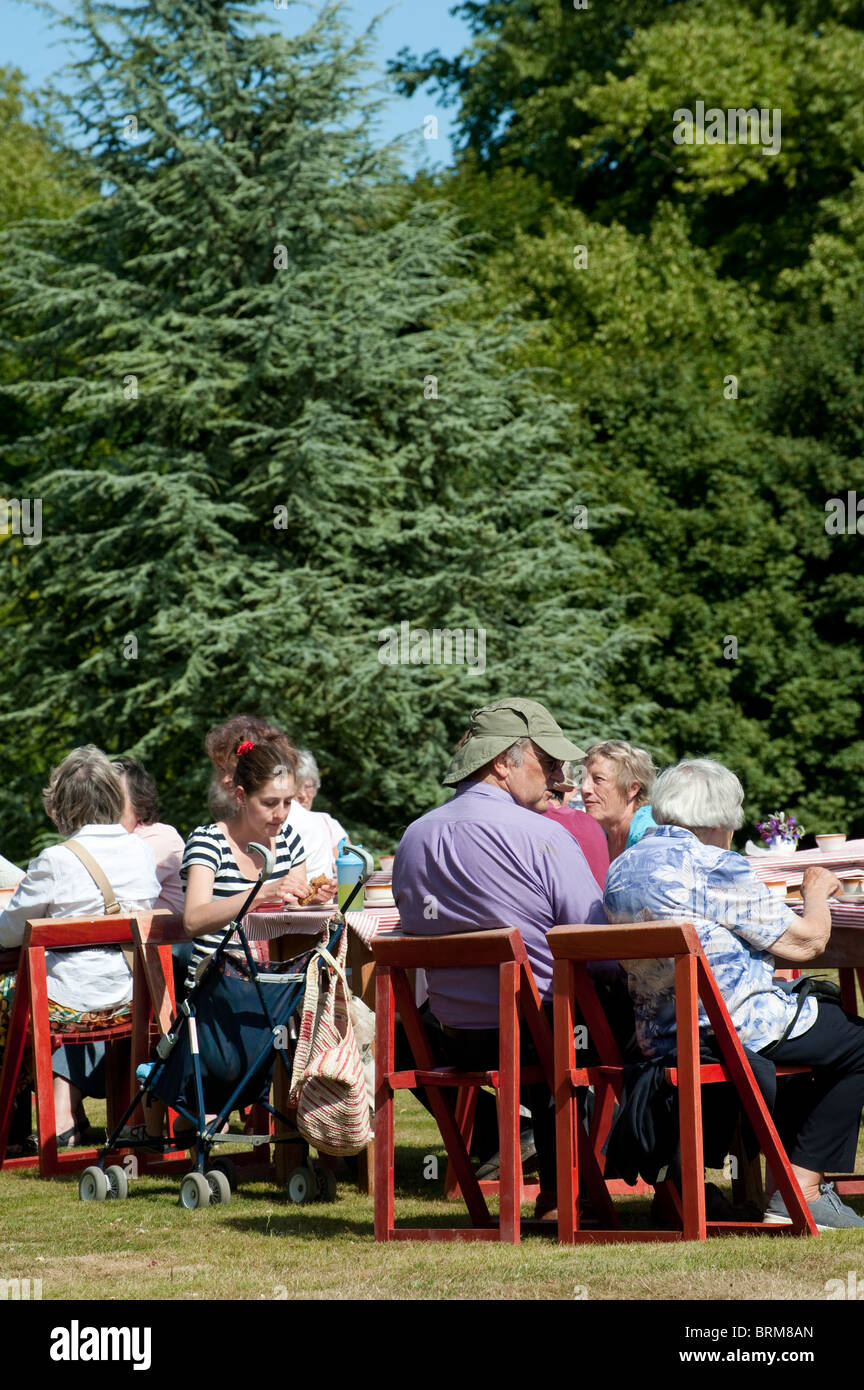 Group of people enjoying refreshments at a garden party in the grounds ...