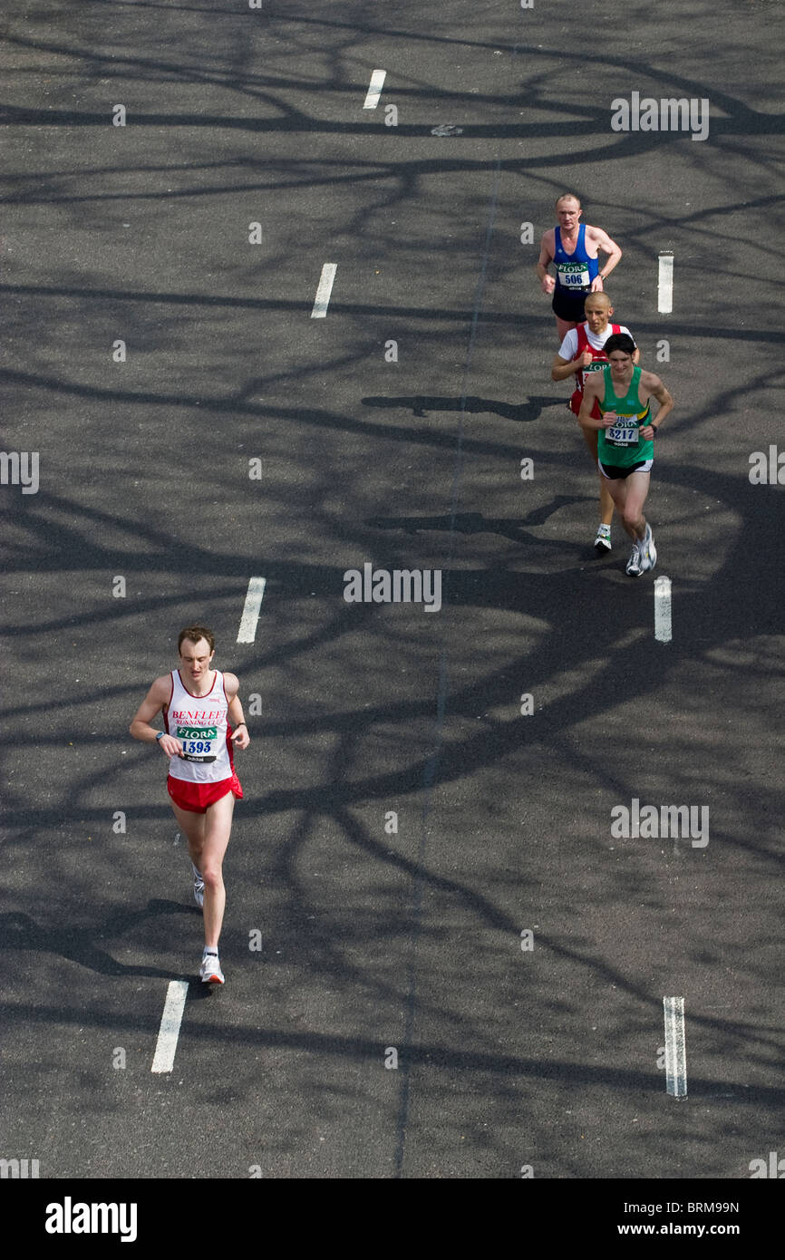 competitive runners taking part in the London Marathon running through ...