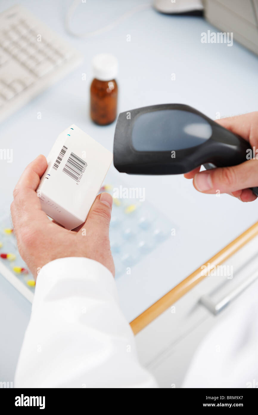 Pharmacist scanning pill box Stock Photo - Alamy