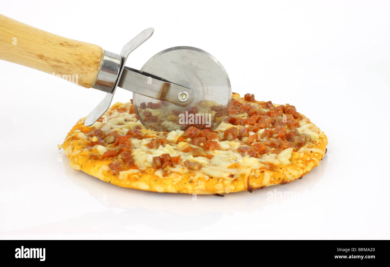 Pepperoni pizza being cut Stock Photo - Alamy