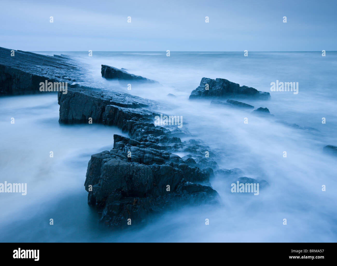 Swirling tide around jagged rocks on Spekes Mill Mouth beach, Hartland ...