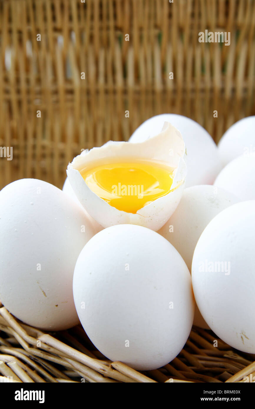 many eggs in a wicker basket of one egg is broken Stock Photo - Alamy