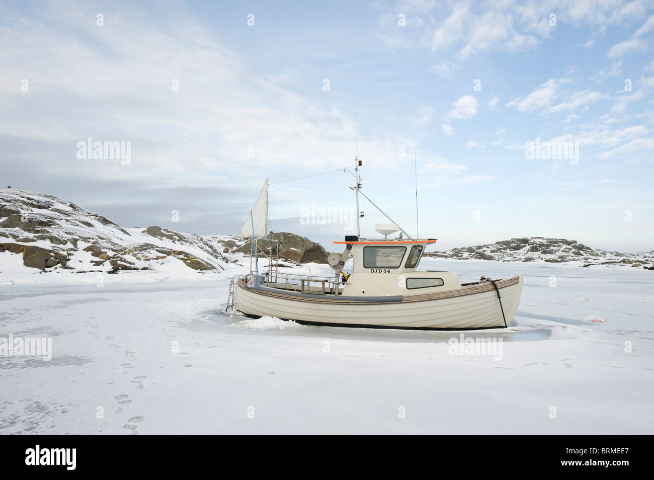 Small fishing boat stock in sea ice Stock Photo - Alamy