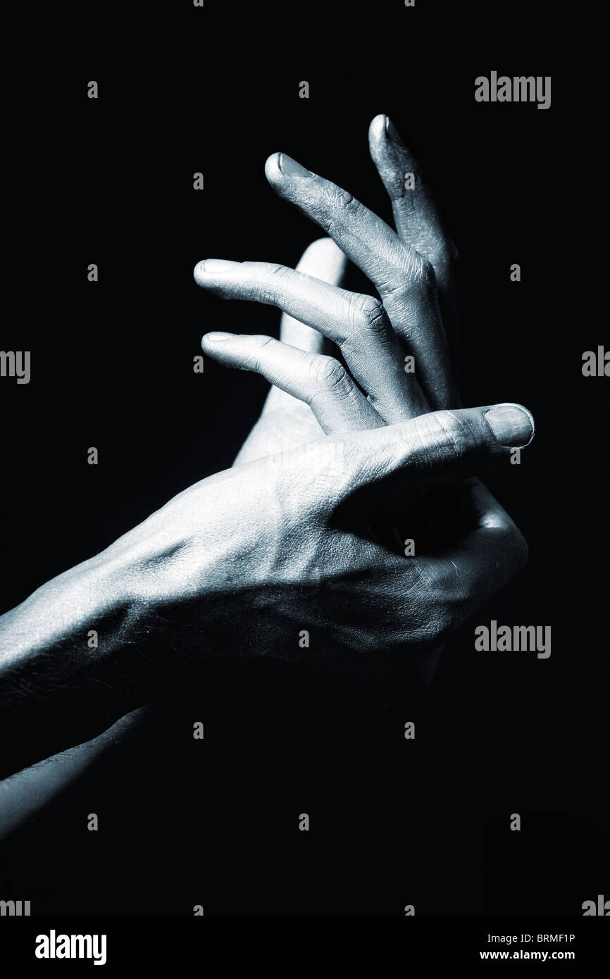 beautiful male hands in silver paint on black background Stock Photo ...