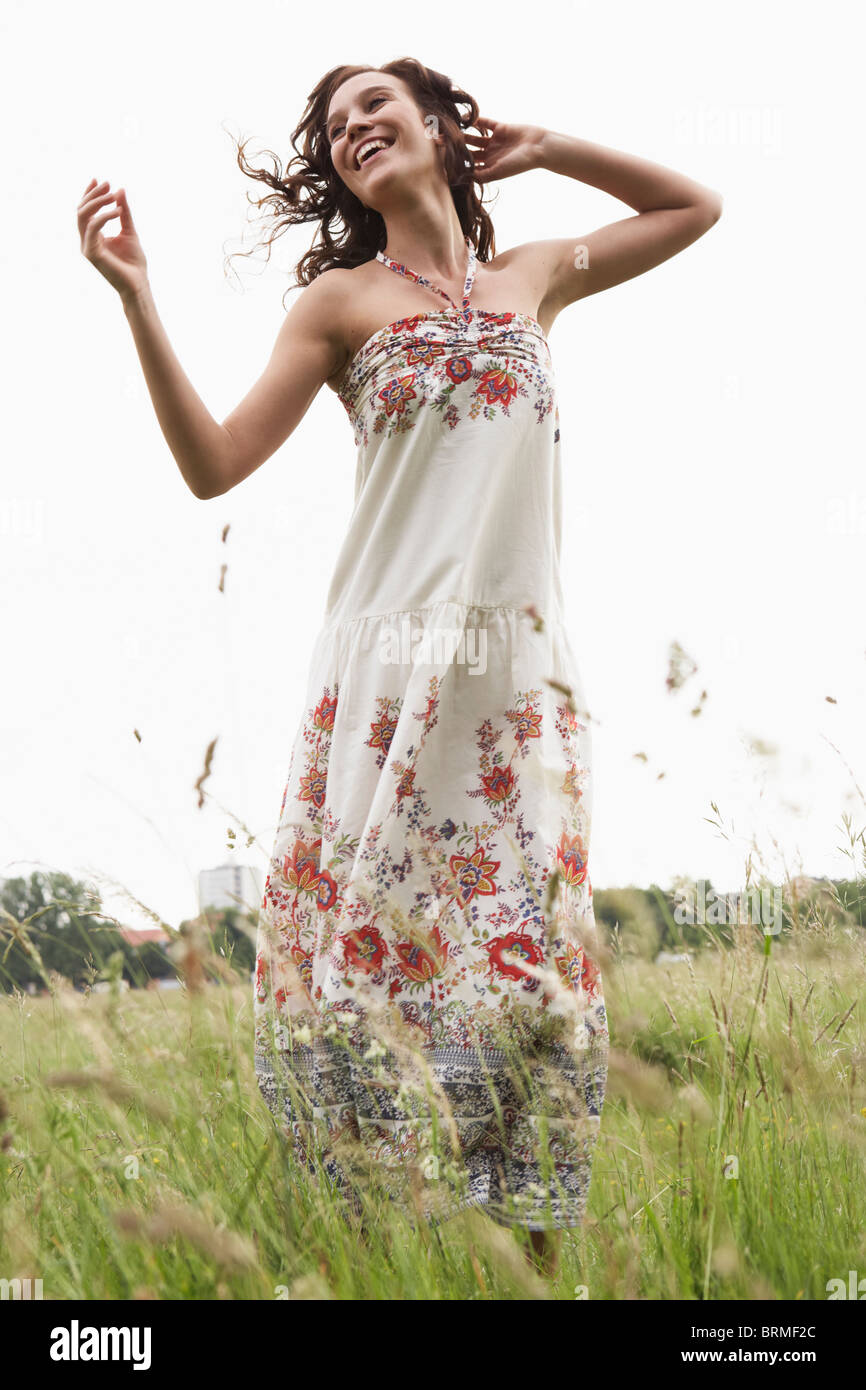 Woman dancing in wild meadow Stock Photo - Alamy