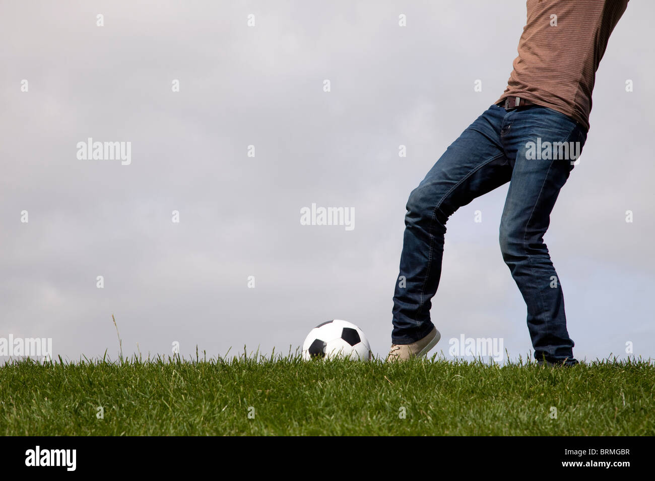 detail of a human foot over a soccer ball in the grass Stock Photo - Alamy