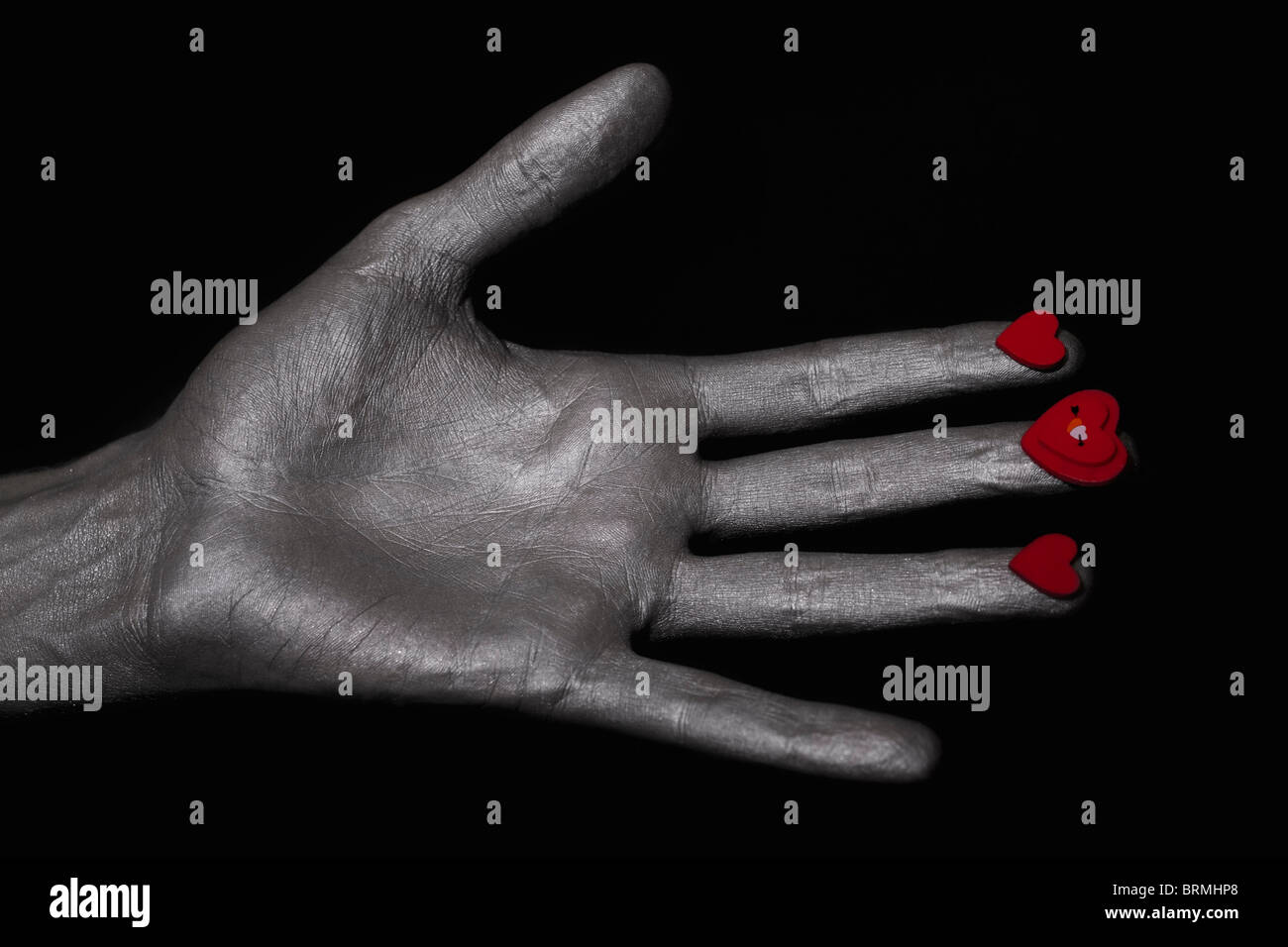 silver man's hand with a heart symbol on his fingers Stock Photo - Alamy