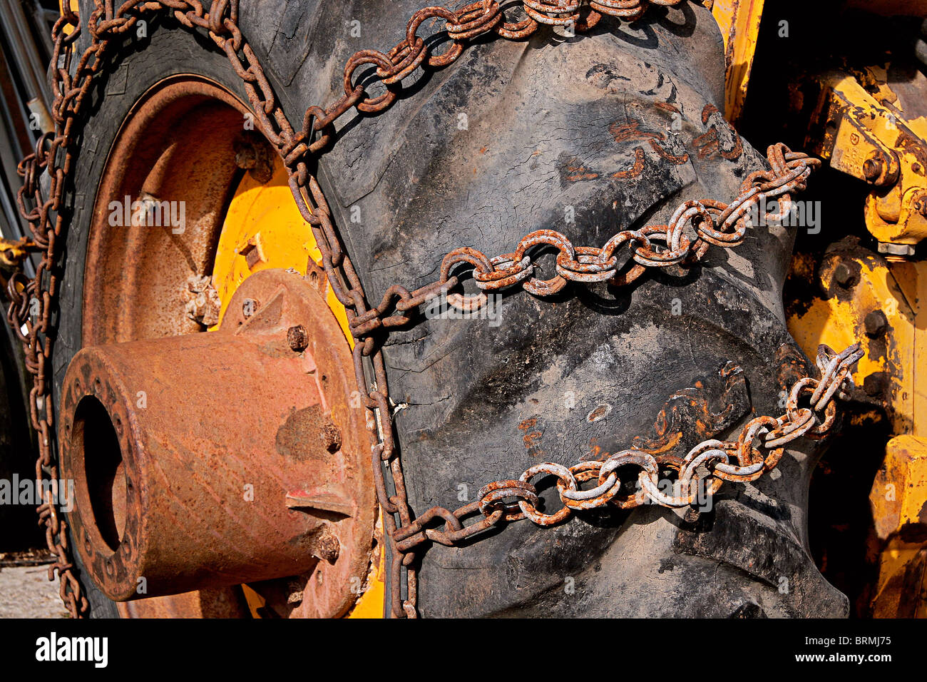 a rusty old chain on a large tractor tire Stock Photo - Alamy