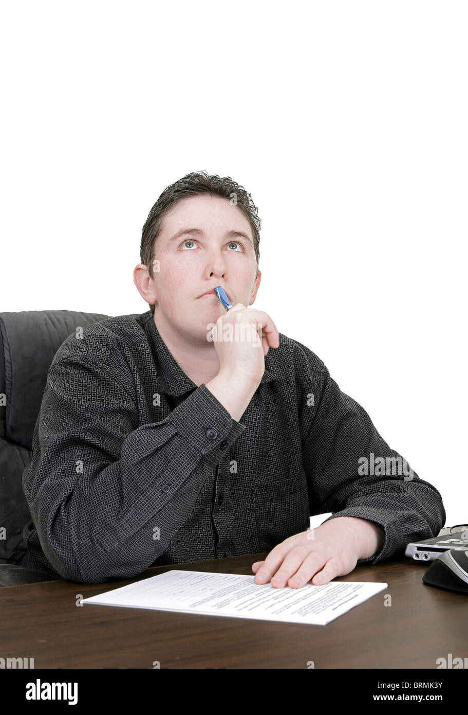 guy thinking as he works on paperwork Stock Photo - Alamy